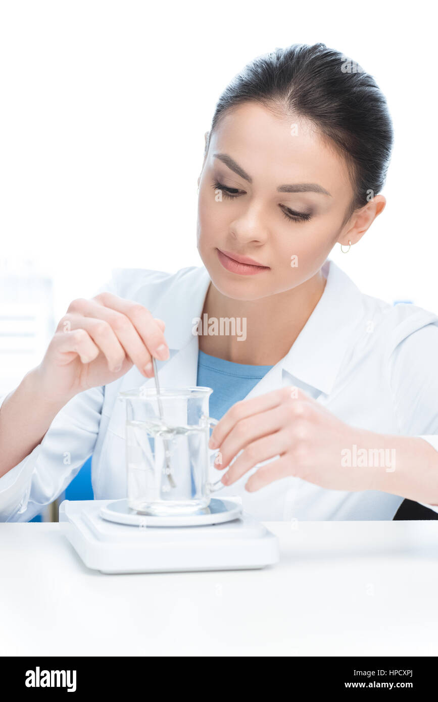 portrait of concentrated scientist working with chemical liquid in lab ...