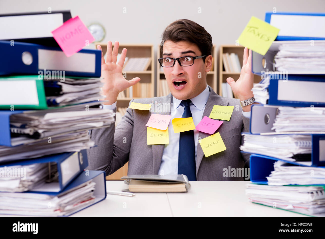 Businessman struggling with multiple priorities Stock Photo - Alamy