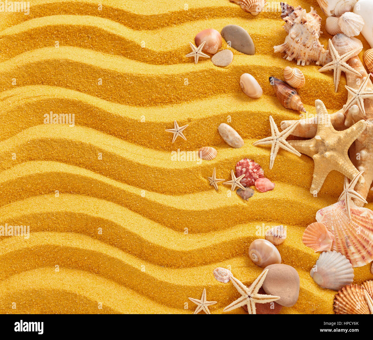 Background with yellow sand, shells and starfishes Stock Photo - Alamy