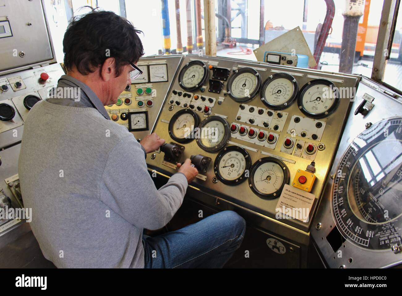 A visitor in front of a historic panel with measure instruments in oil ...