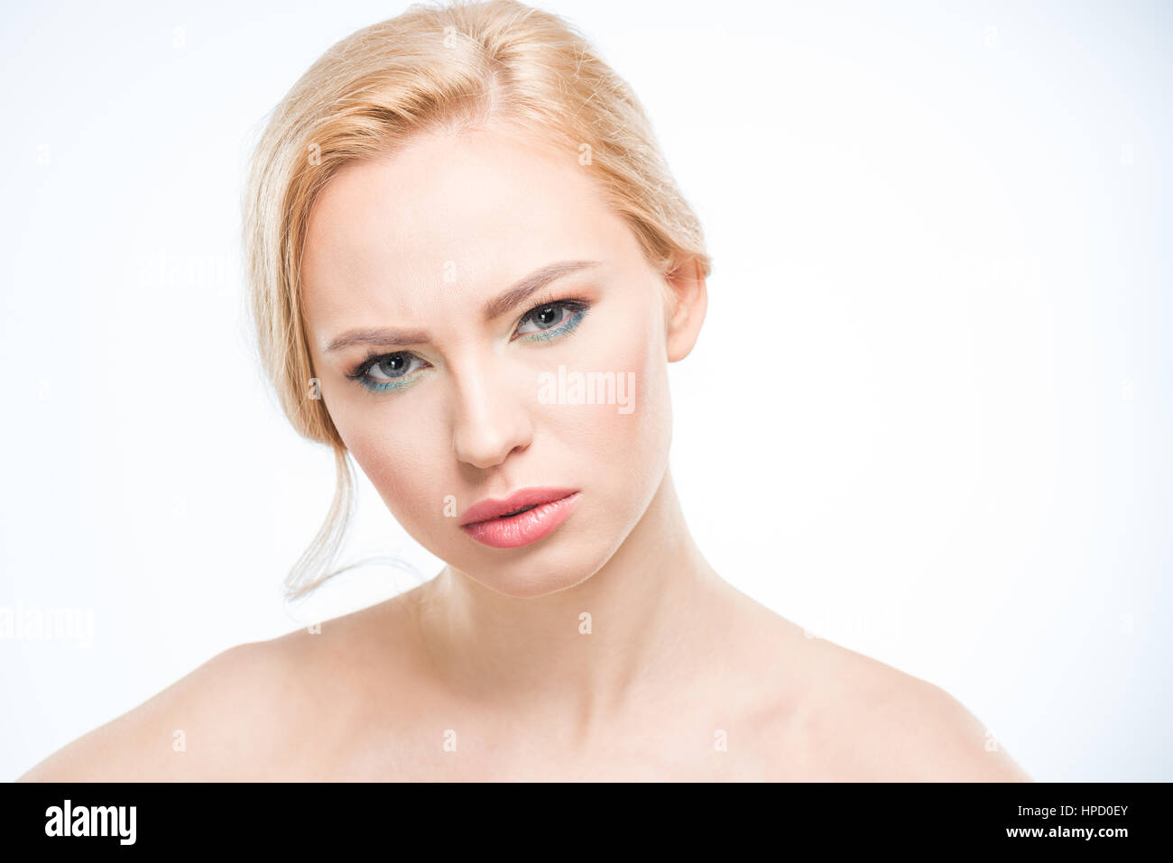 Beautiful young serious woman with stylish makeup looking at camera ...