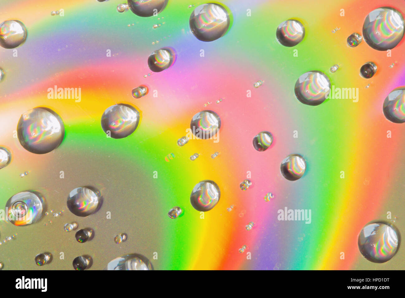 Colorful abstract formed by water droplets on the surface of a cd Stock ...