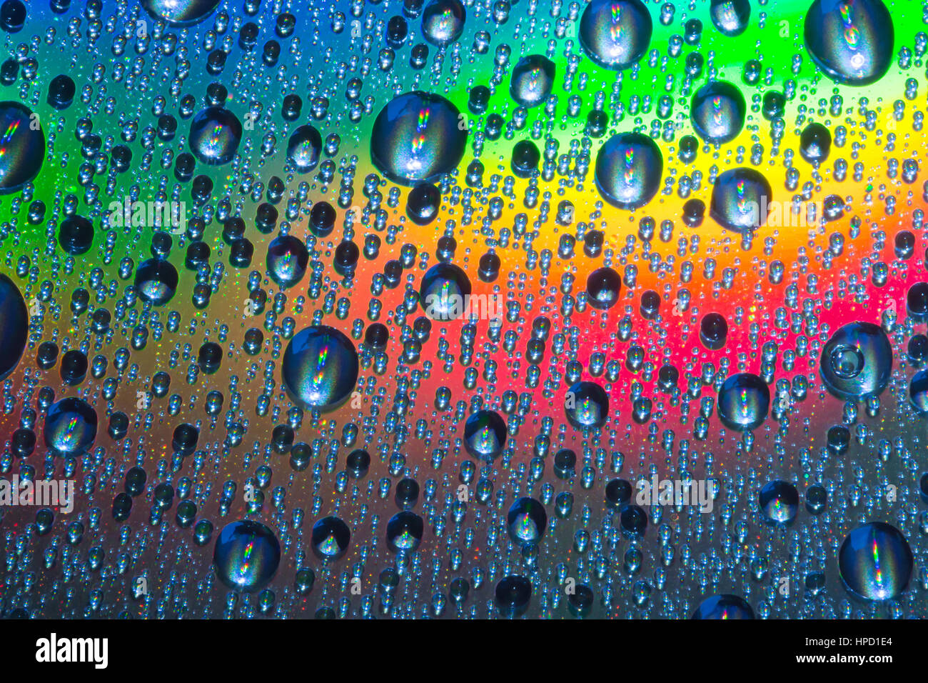 Colorful abstract formed by water droplets on the surface of a cd Stock ...