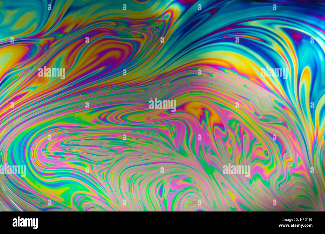 Psychedelic abstract formed by light on the surface of a soap bubble ...