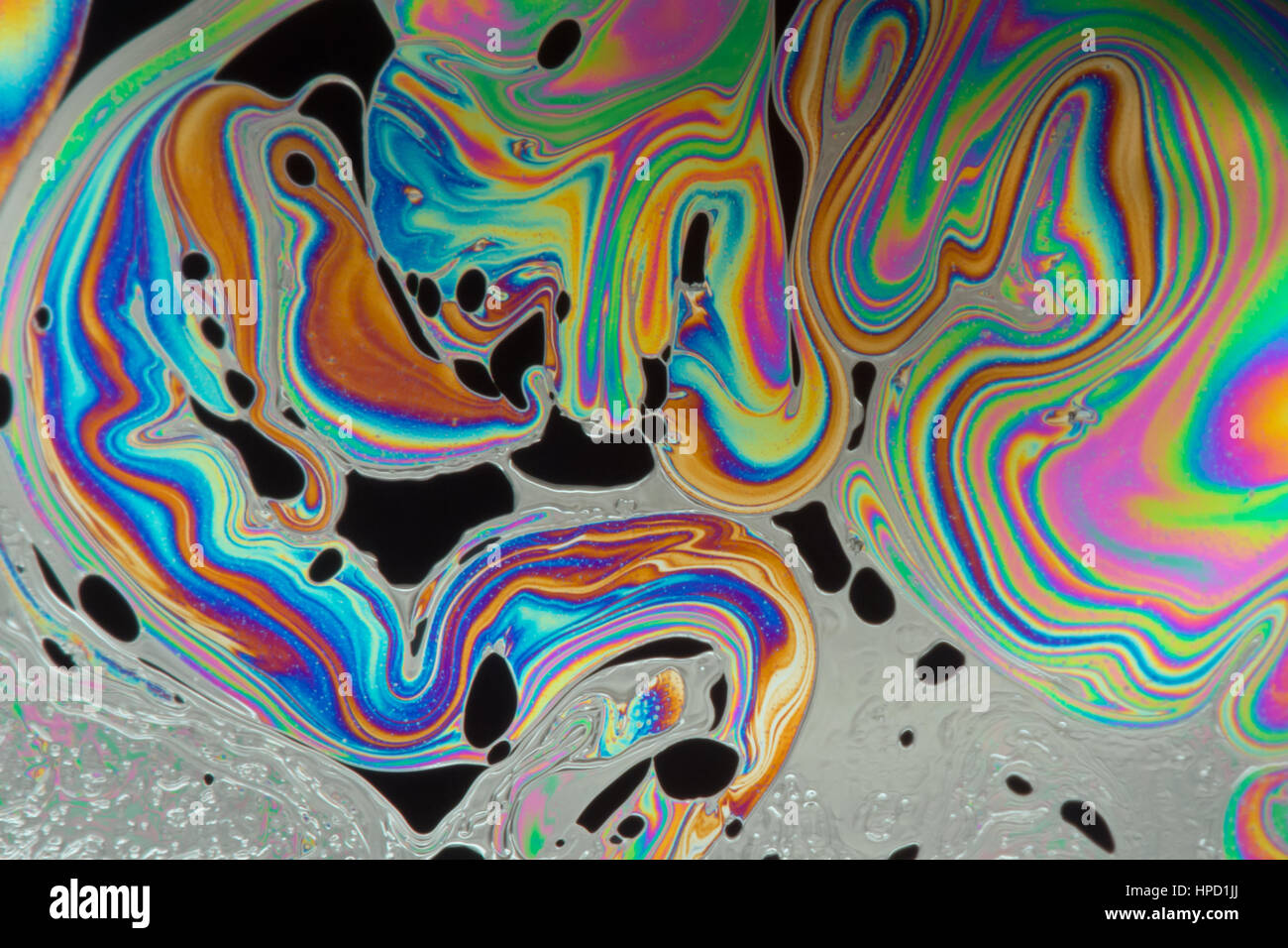 Psychedelic abstract formed by light on the surface of a soap bubble ...