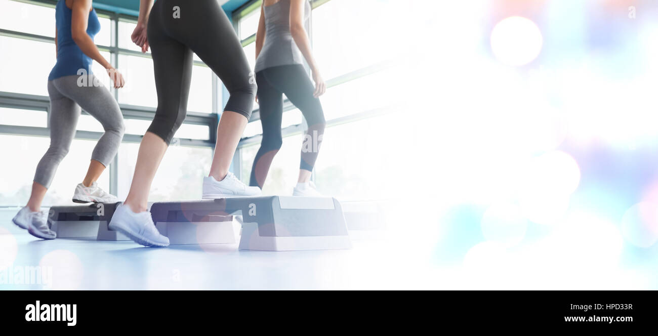Three women doing aerobics against glowing background Stock Photo - Alamy