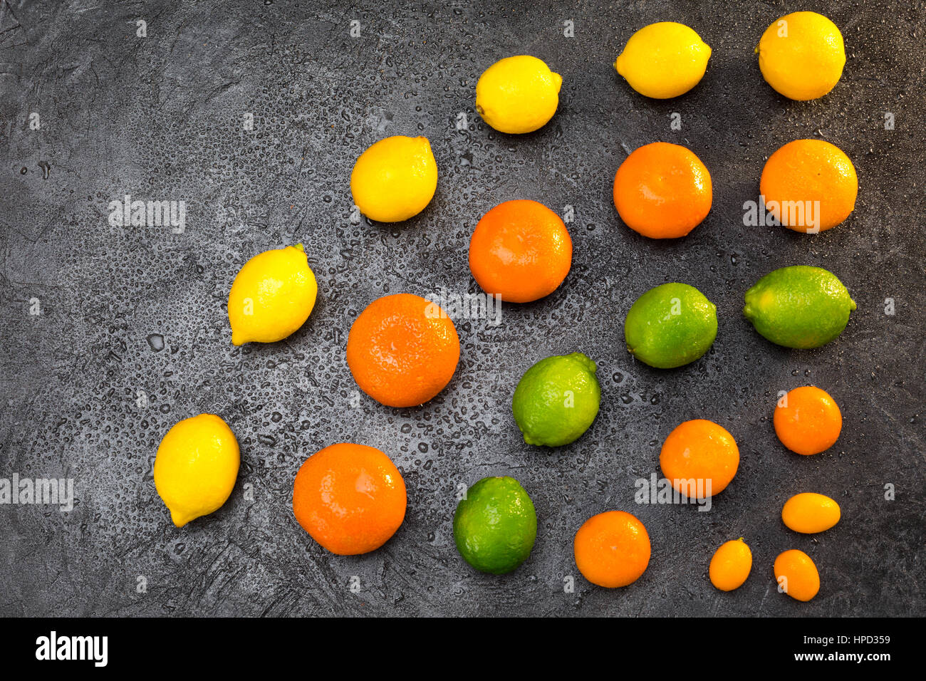 top view of fresh whole citrus fruits in rows on black Stock Photo - Alamy
