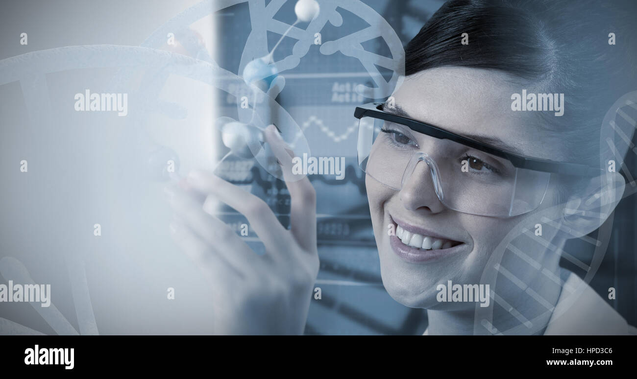 Female scientist holding molecular model against panoramic view of ...