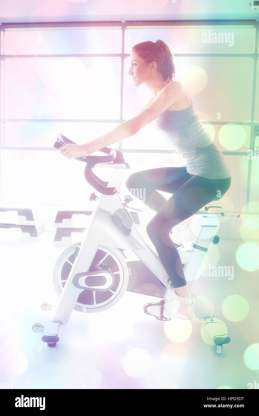 Abstract background against side view of woman energetically riding ...