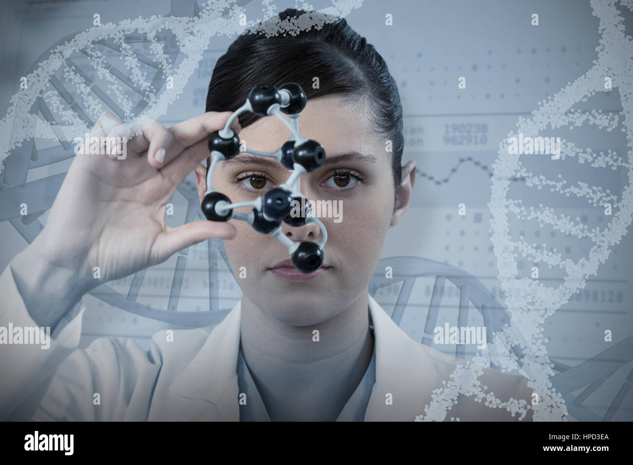 Female scientist looking through molecular model against panoramic view ...