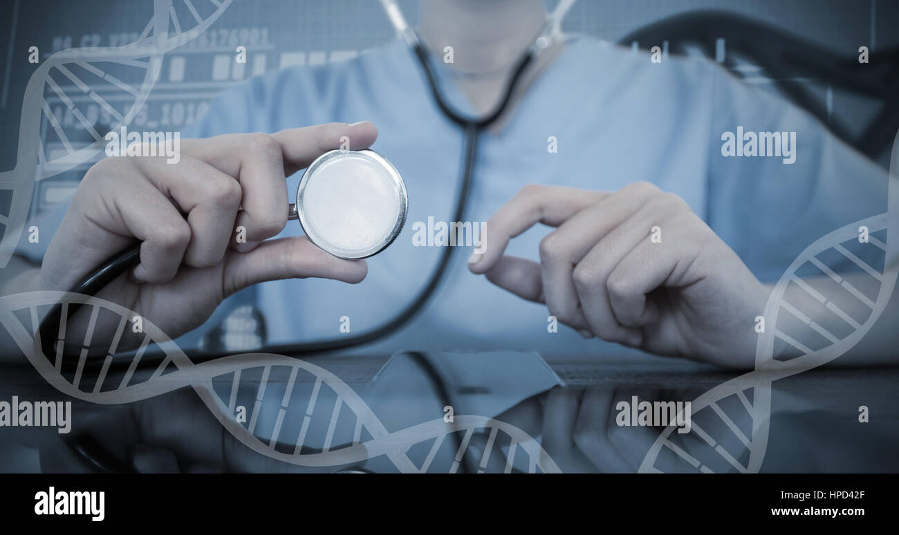Mid-section of female doctor examining digital tablet with stethoscope ...