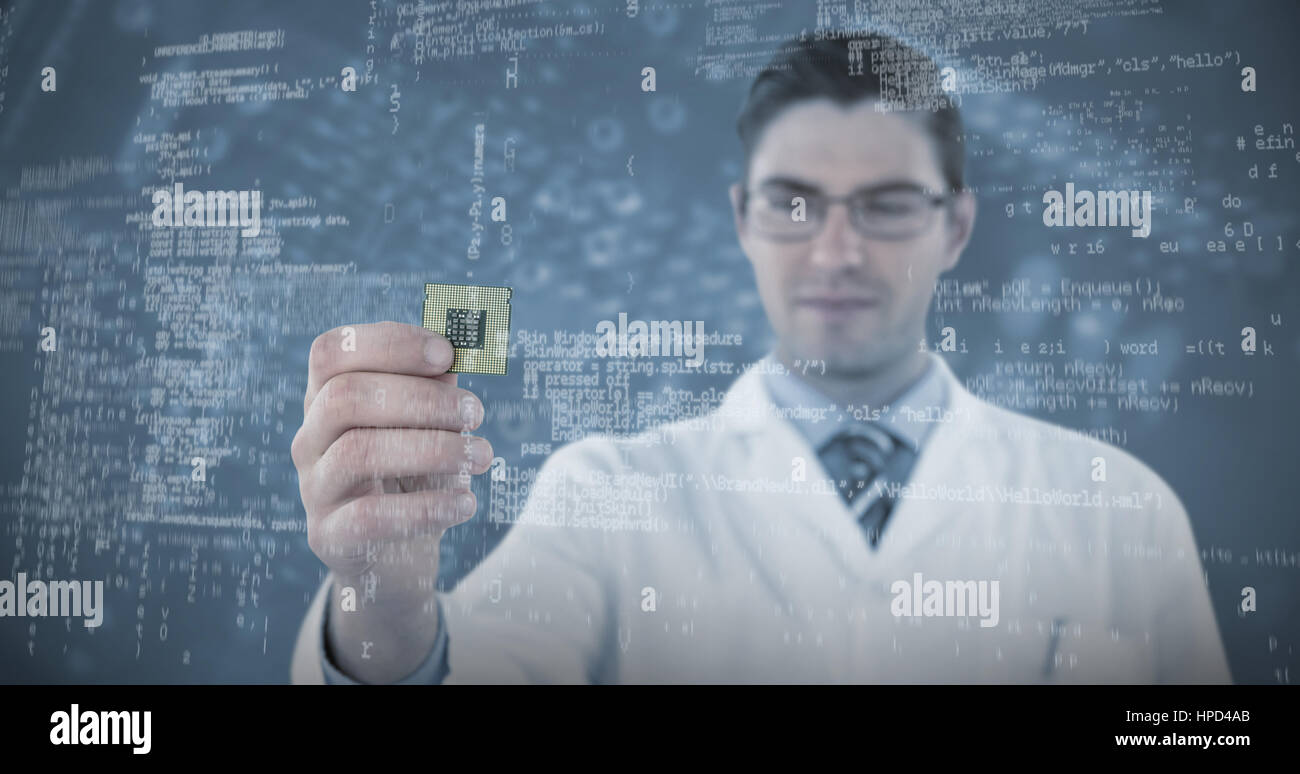 Engineer holding computer chip against blue printed circuit board Stock ...