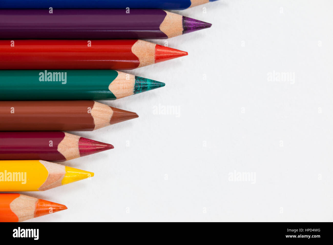 Colorful color pencil arranged in diagonal line on white background ...