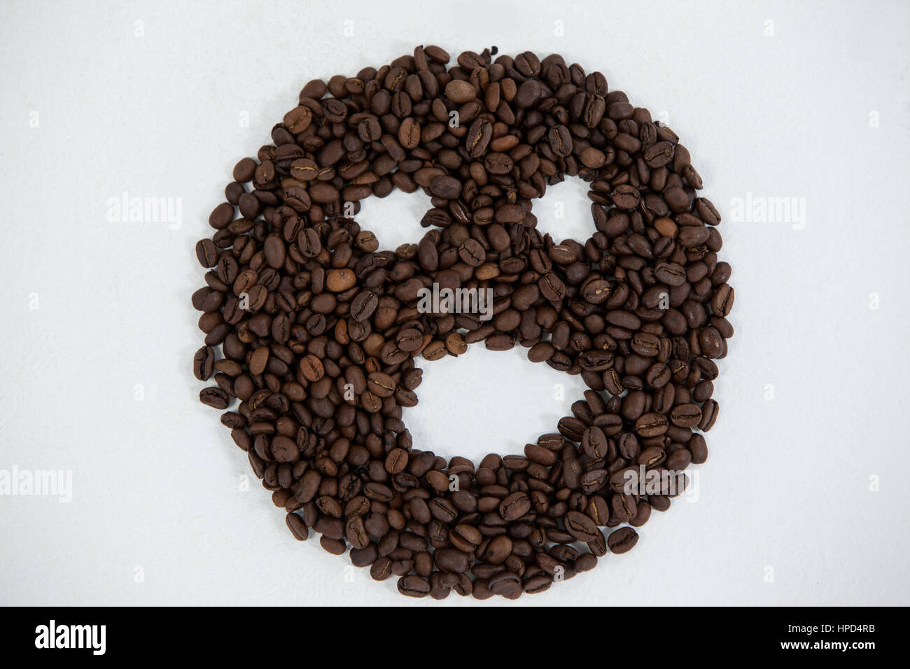 Coffee beans forming face on white background Stock Photo - Alamy