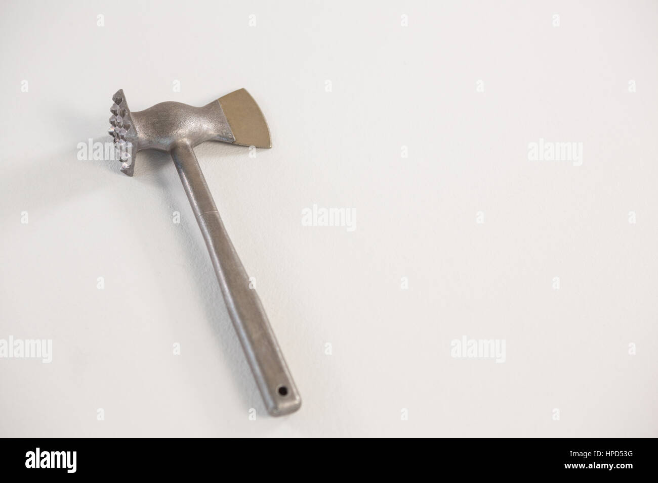 Meat cutting hammer against white background Stock Photo - Alamy