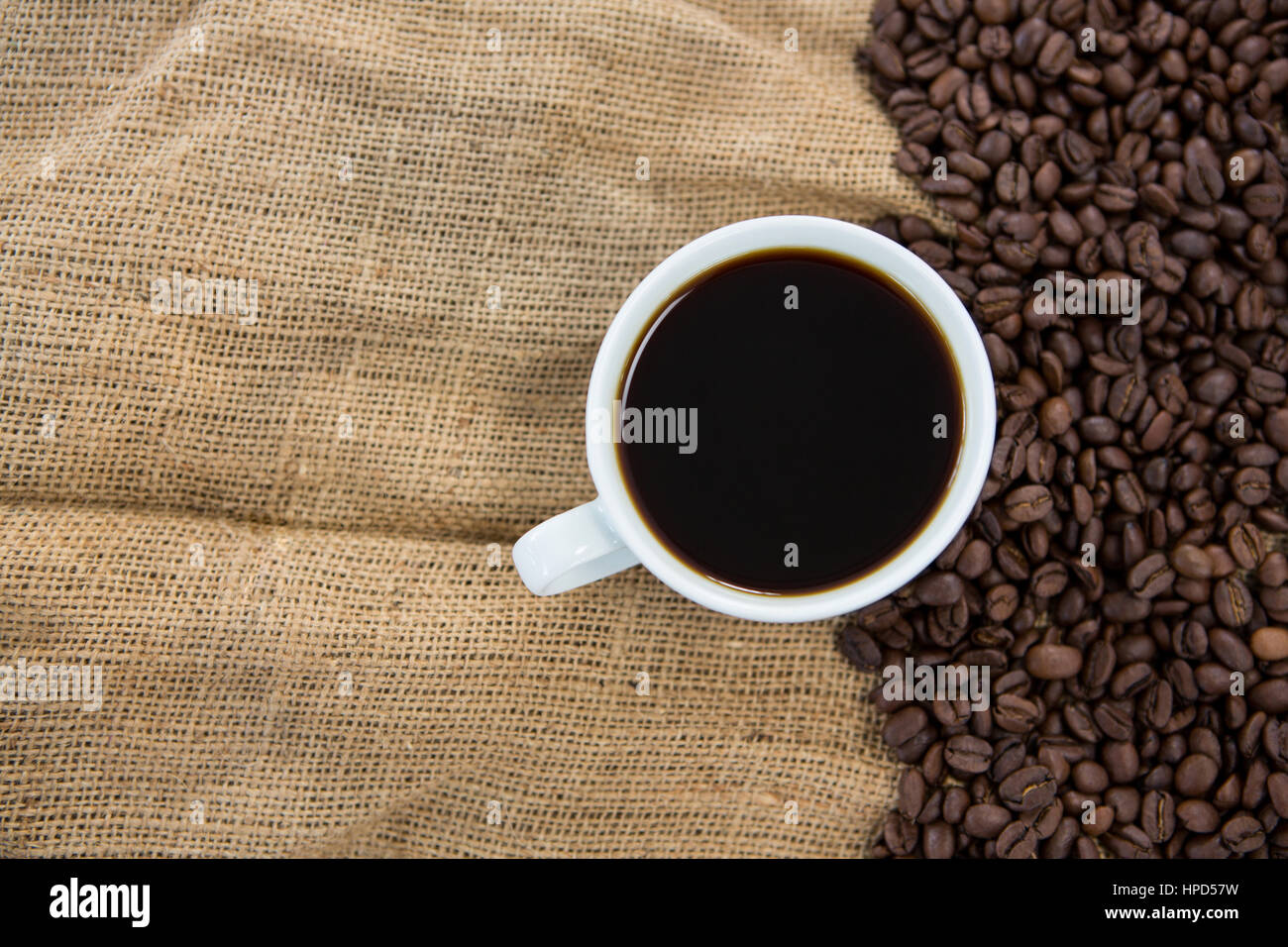 Black coffee and coffee beans on sack textile Stock Photo - Alamy