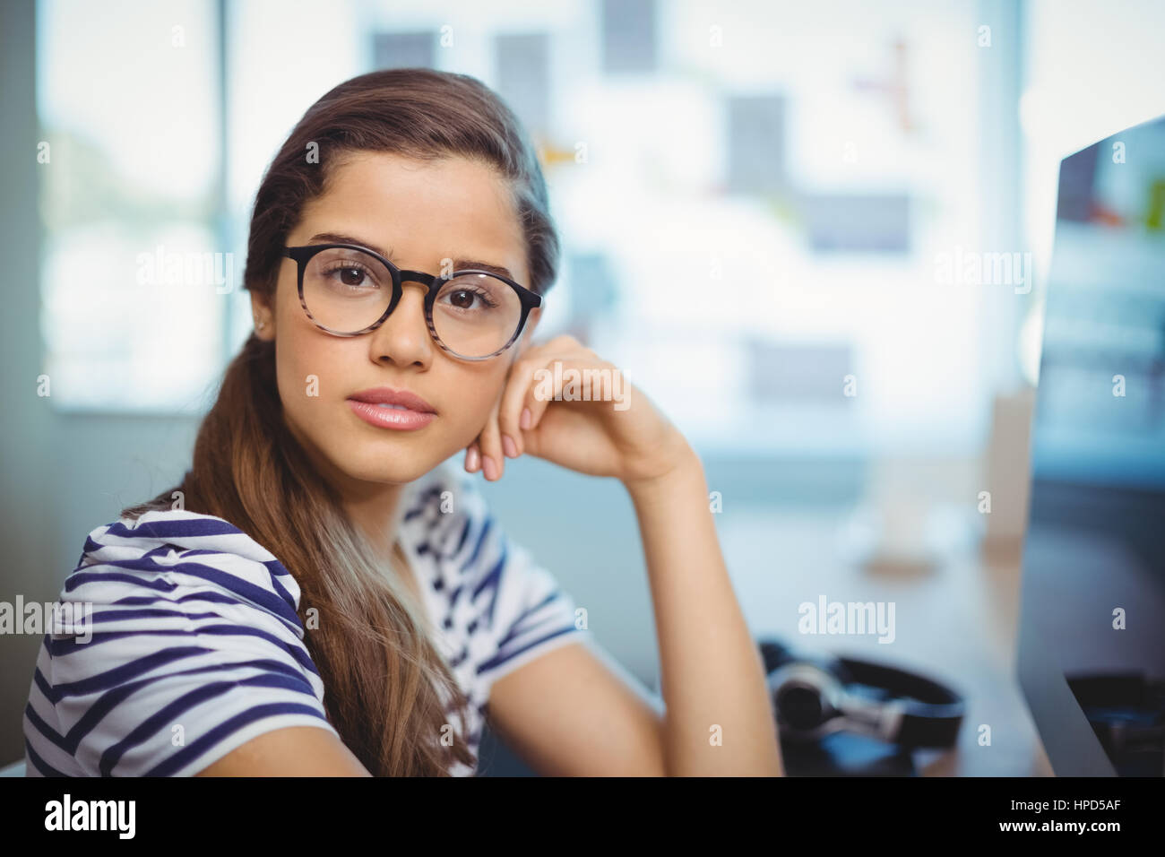 Portrait of young female graphic designer in office Stock Photo - Alamy