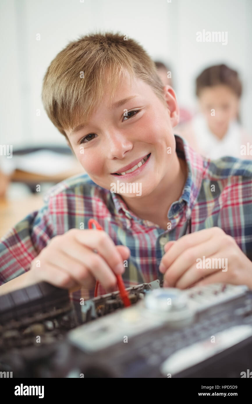 Schoolboy repairing a printer in the classroom at school Stock Photo ...