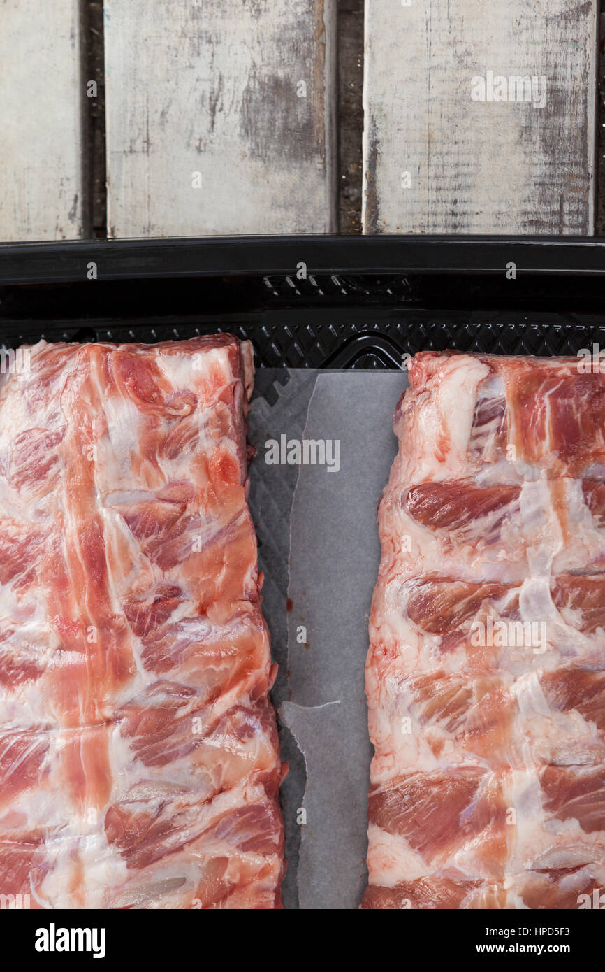 Beef ribs in black box against wooden background Stock Photo - Alamy