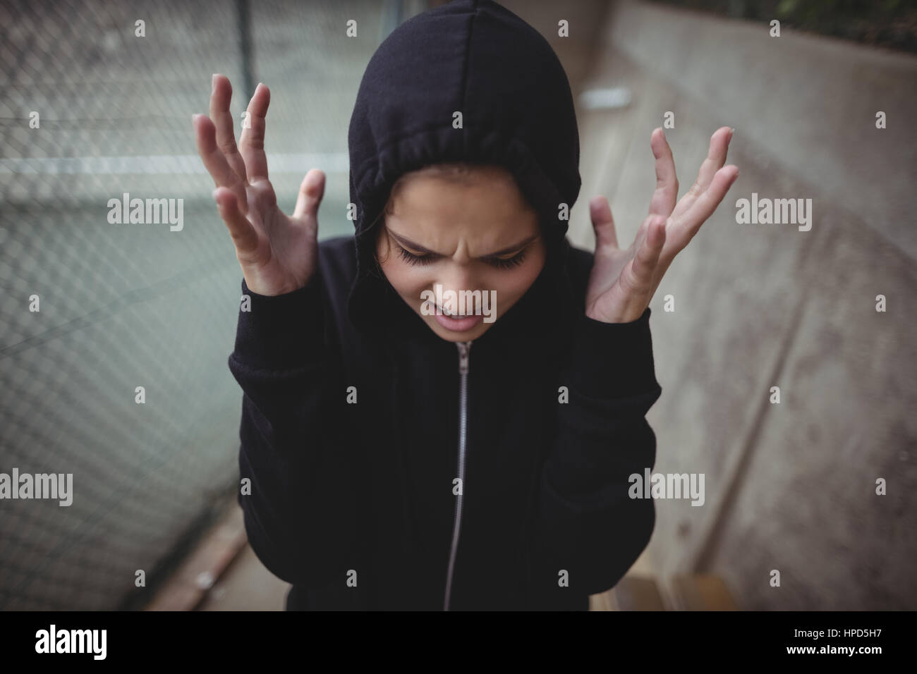Close-up of angry teenage girl standing at school campus Stock Photo ...