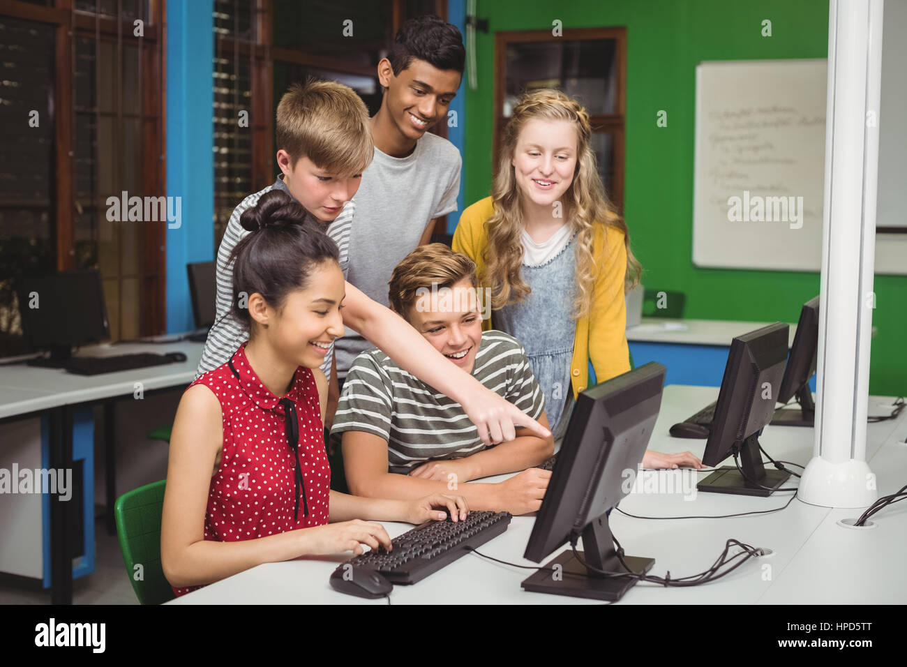 Smiling students studying in computer classroom at school Stock Photo ...