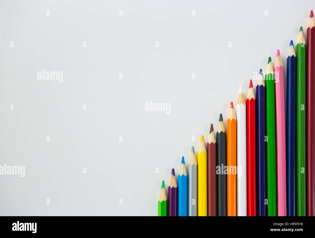 Colored pencils arranged in diagonal line on white background Stock ...
