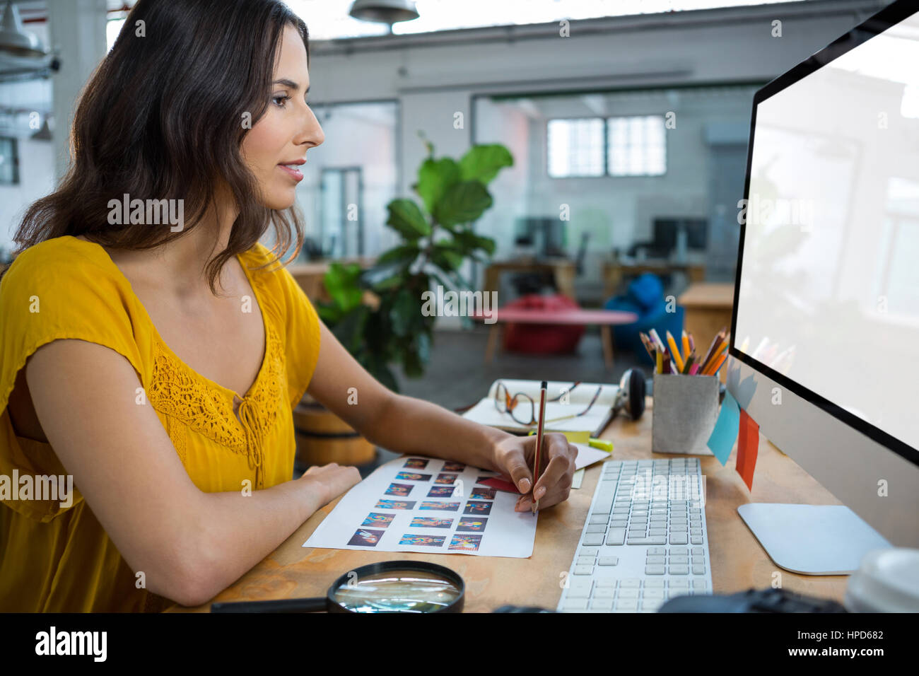 Female graphic designer working on computer in creative office Stock ...