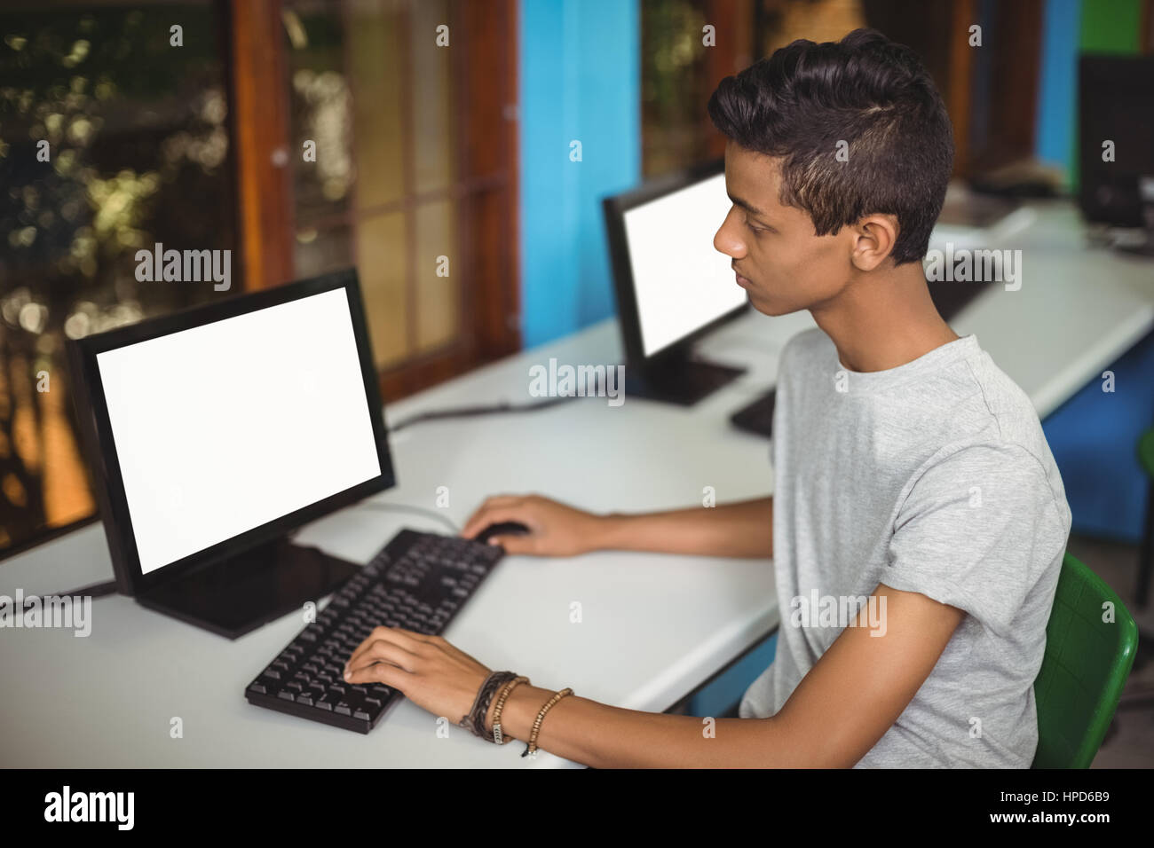 Schoolboy studying in computer classroom at school Stock Photo - Alamy