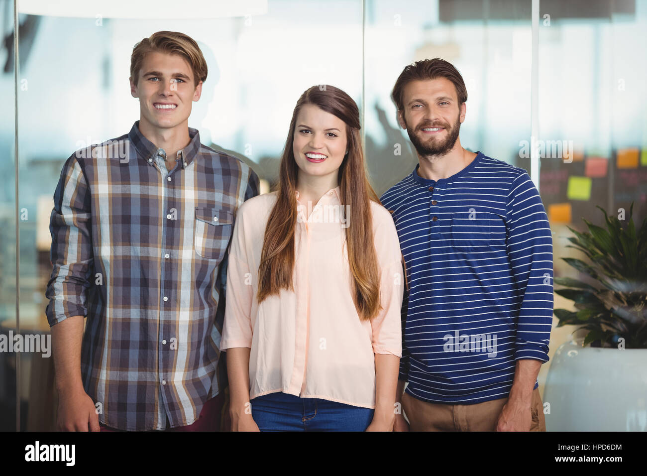 Portrait of happy business executives standing in office Stock Photo ...