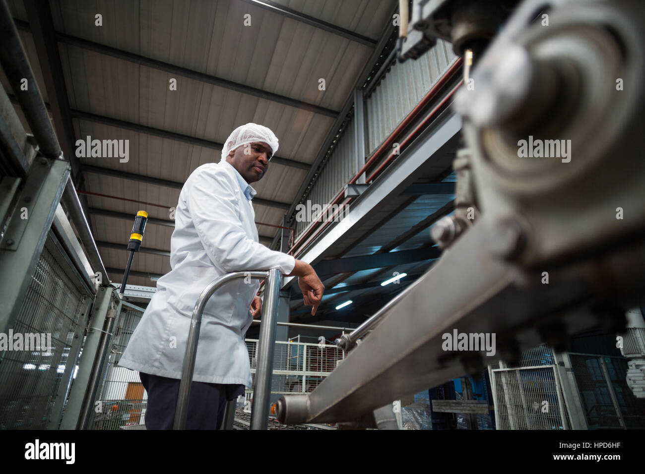 Factory engineer monitoring production line in drinks production plant ...