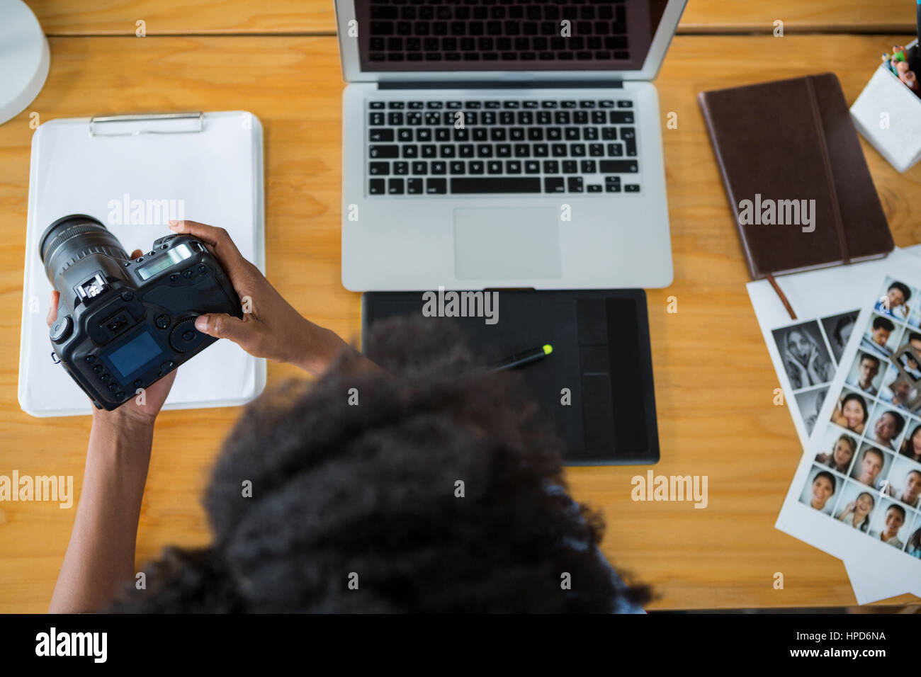 Female graphic designer using digital camera on desk Stock Photo - Alamy