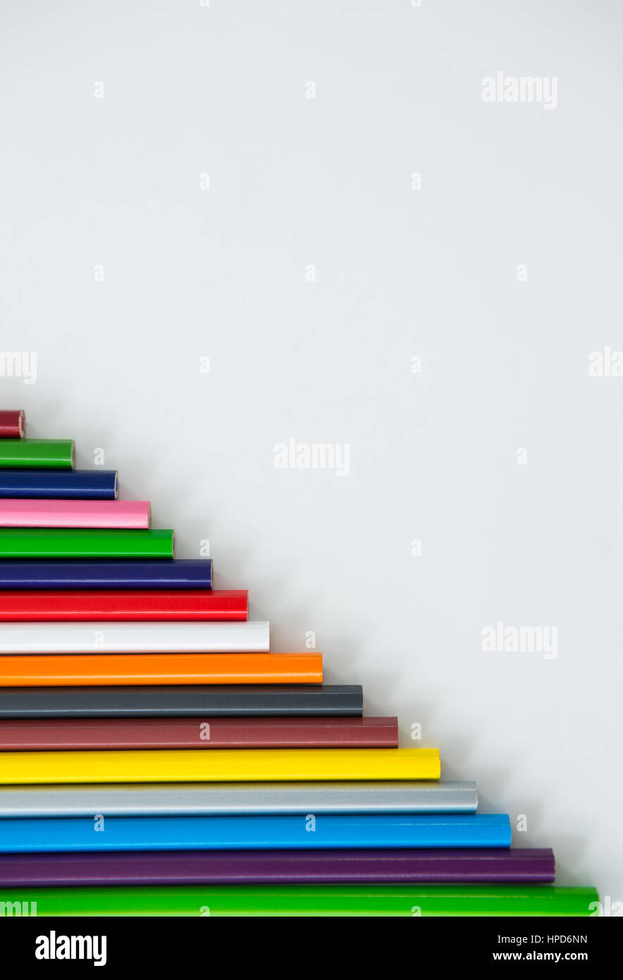 Colored pencils arranged in diagonal line on white background Stock ...