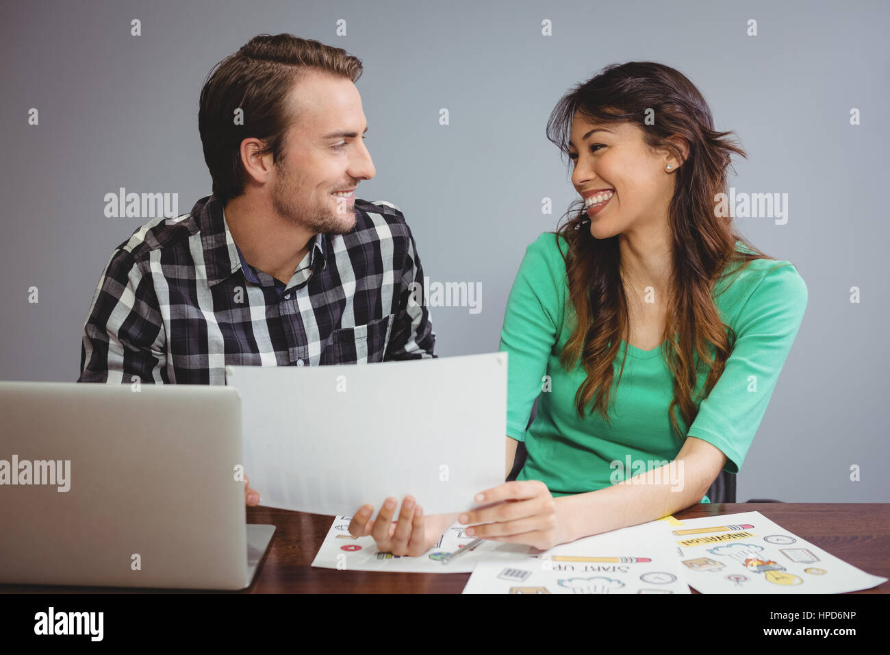 Male and graphic designers working together in conference room at ...