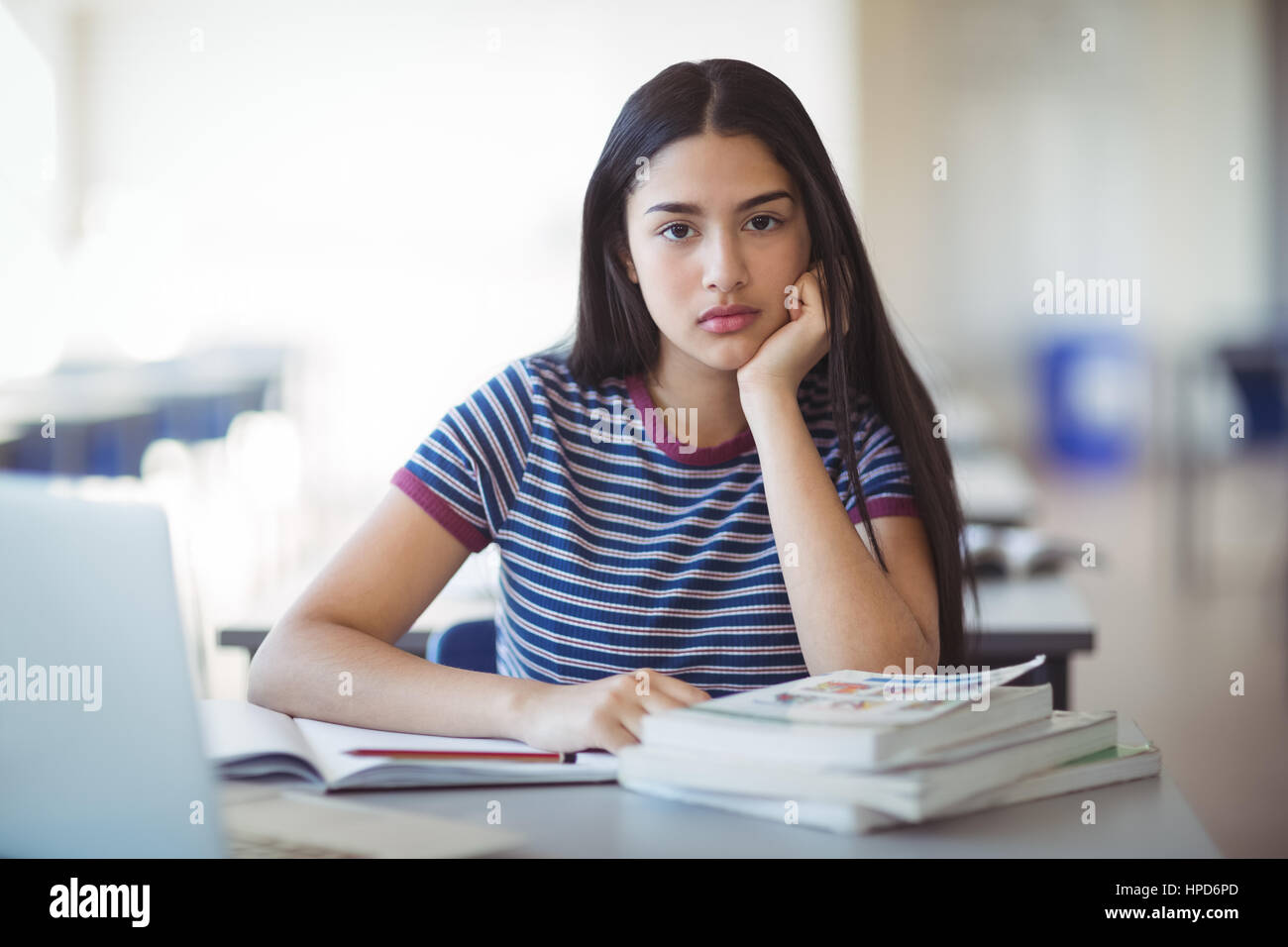 Sad girl sitting in classroom hi-res stock photography and images - Alamy