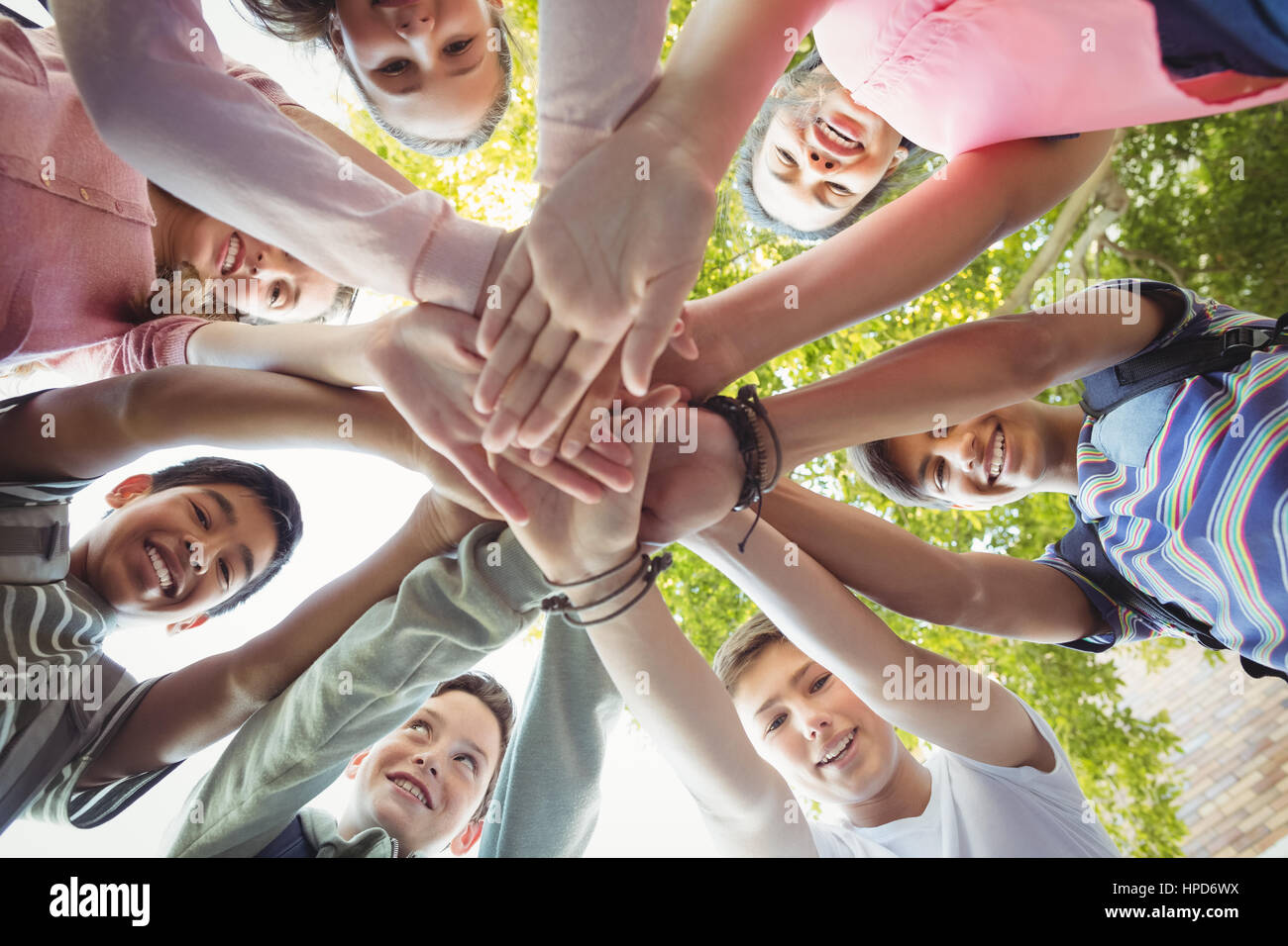 Happy school kids forming hand stack in campus at school Stock Photo ...