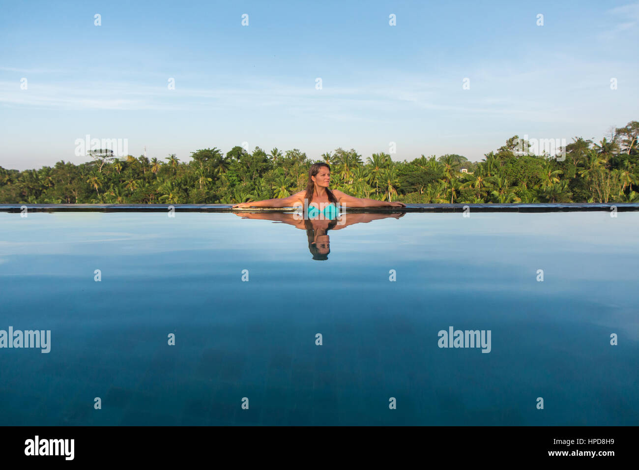 Woman enjoying an infinity pool. Bali, Indonesia Stock Photo - Alamy