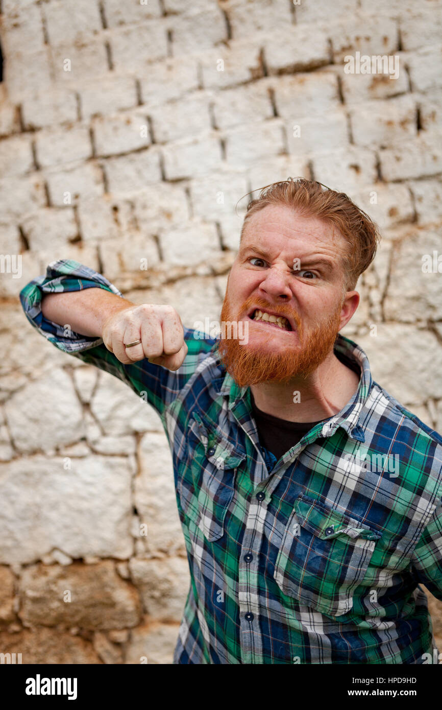 Angry red haired hipster man with blue plaid shirt Stock Photo - Alamy