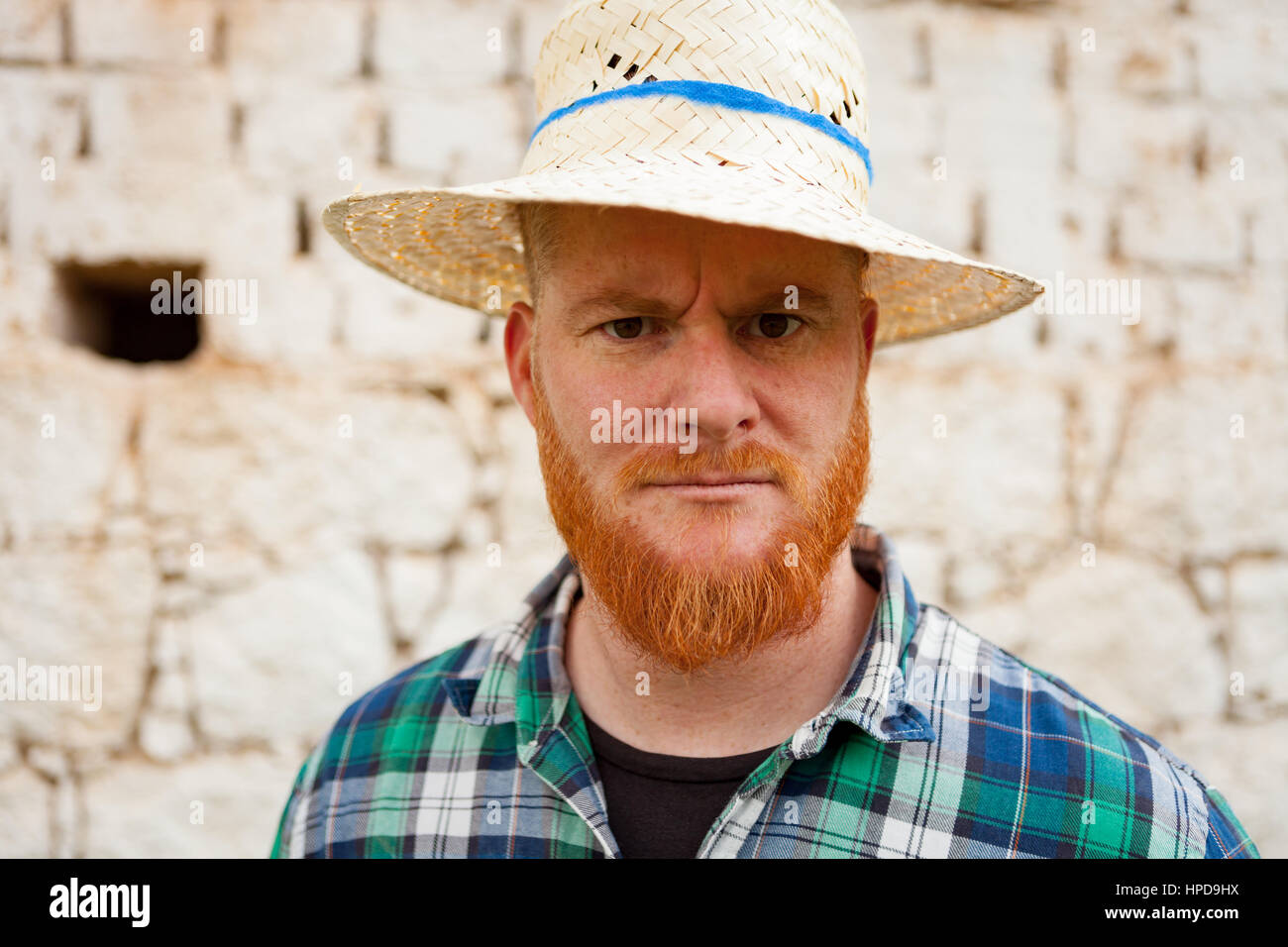 Red haired man with a straw hat in a rural enviroment Stock Photo - Alamy