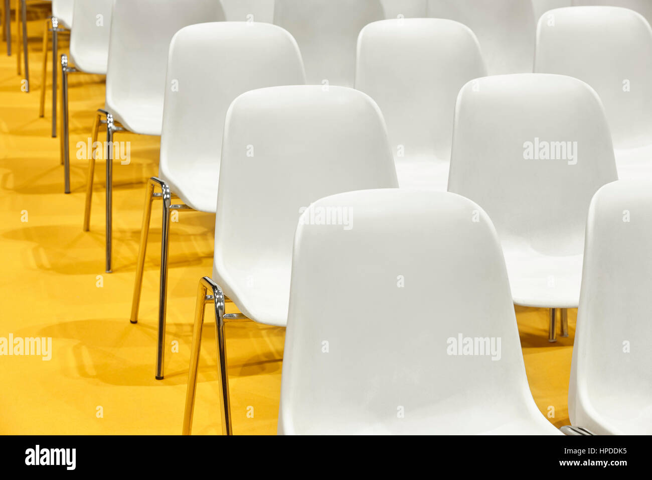 Conference room with plastic chairs detail and yellow floor. Horizontal ...