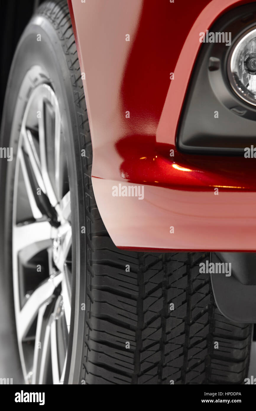 Red car body and alloy wheels detail. Vertical Stock Photo - Alamy