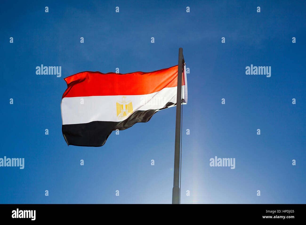 National flag of Egypt on a flagpole in front of blue sky Stock Photo ...