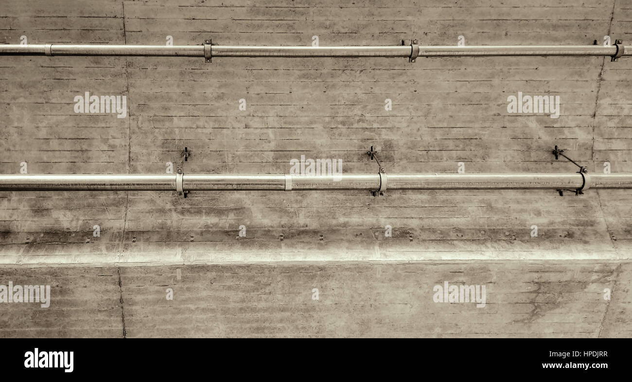 Stone wall background texture with tubes Stock Photo - Alamy