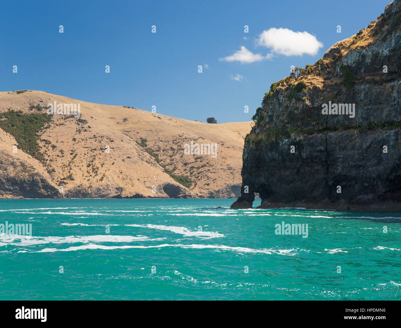 Akaroa, Canterbury, New Zealand. View across the turquoise waters off ...