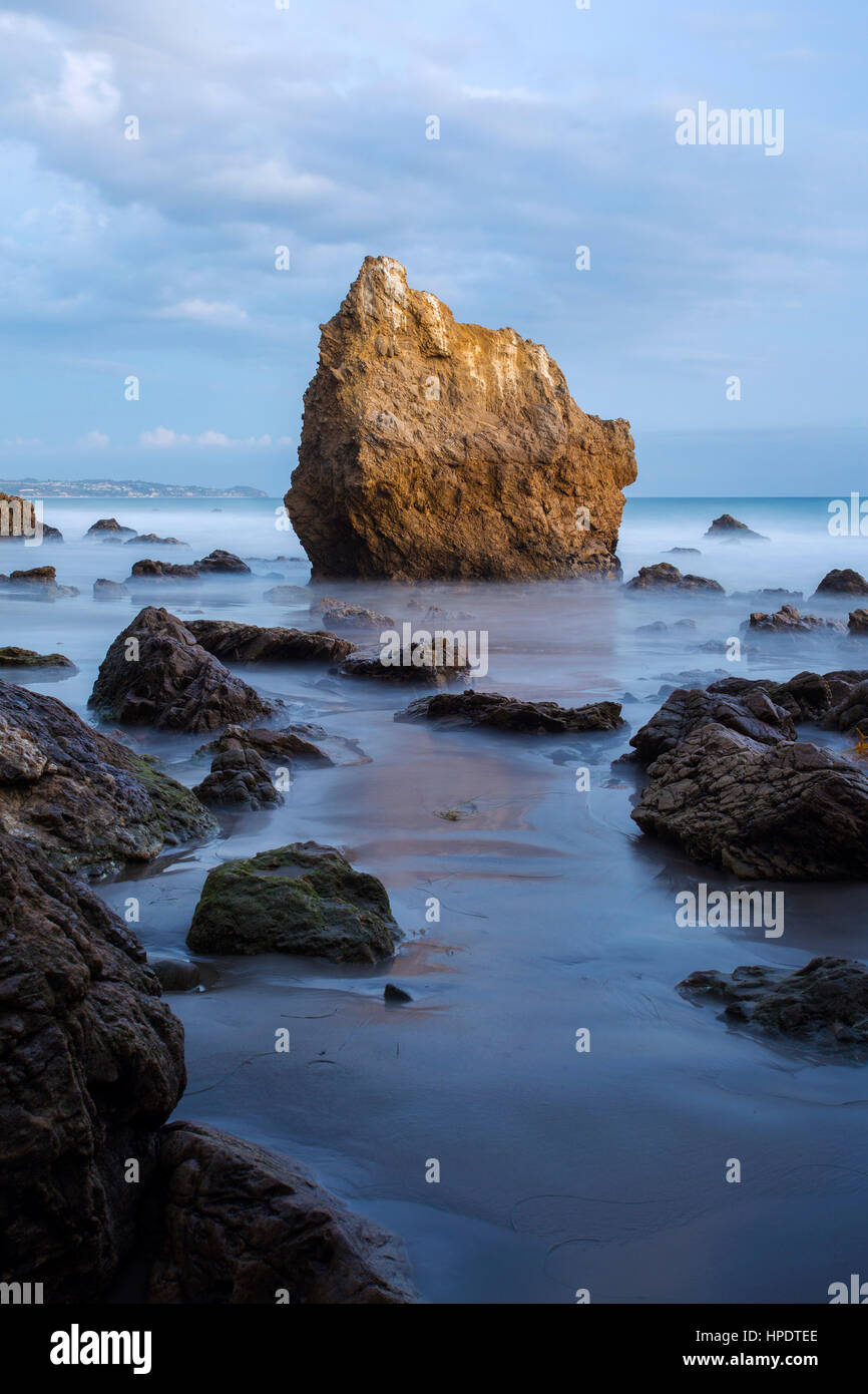 A large rock at El Matador State Beach in California at dusk Stock ...