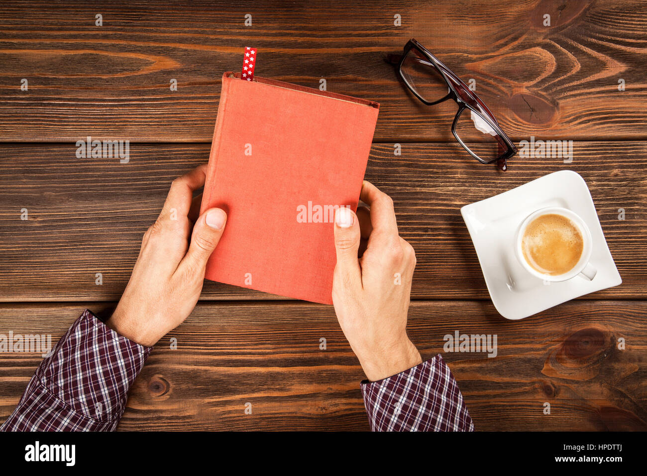 Man holding a red book Stock Photo - Alamy