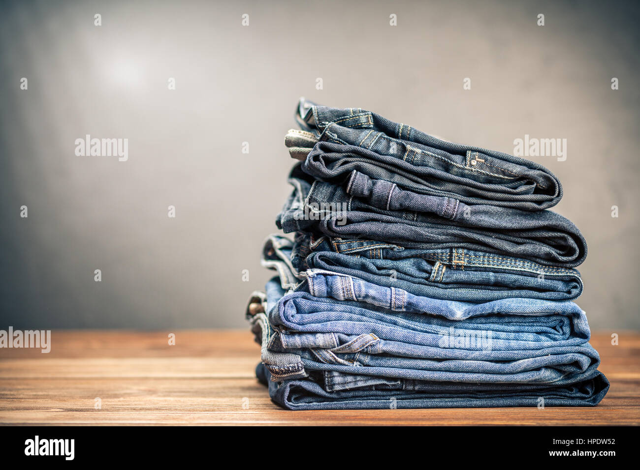 Jeans arranged in a stack Stock Photo - Alamy