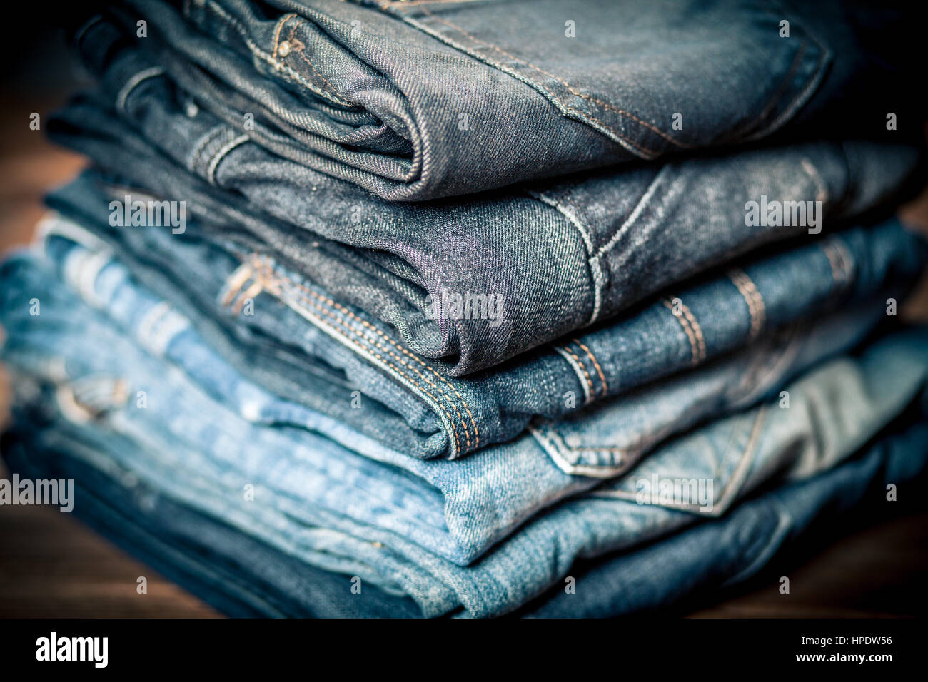 Jeans arranged in a stack Stock Photo - Alamy
