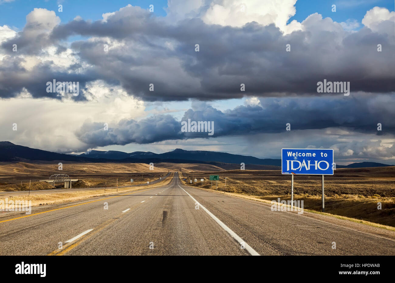 Dramatic sky over highway / interstate I-15 with "Welcome to Idaho ...