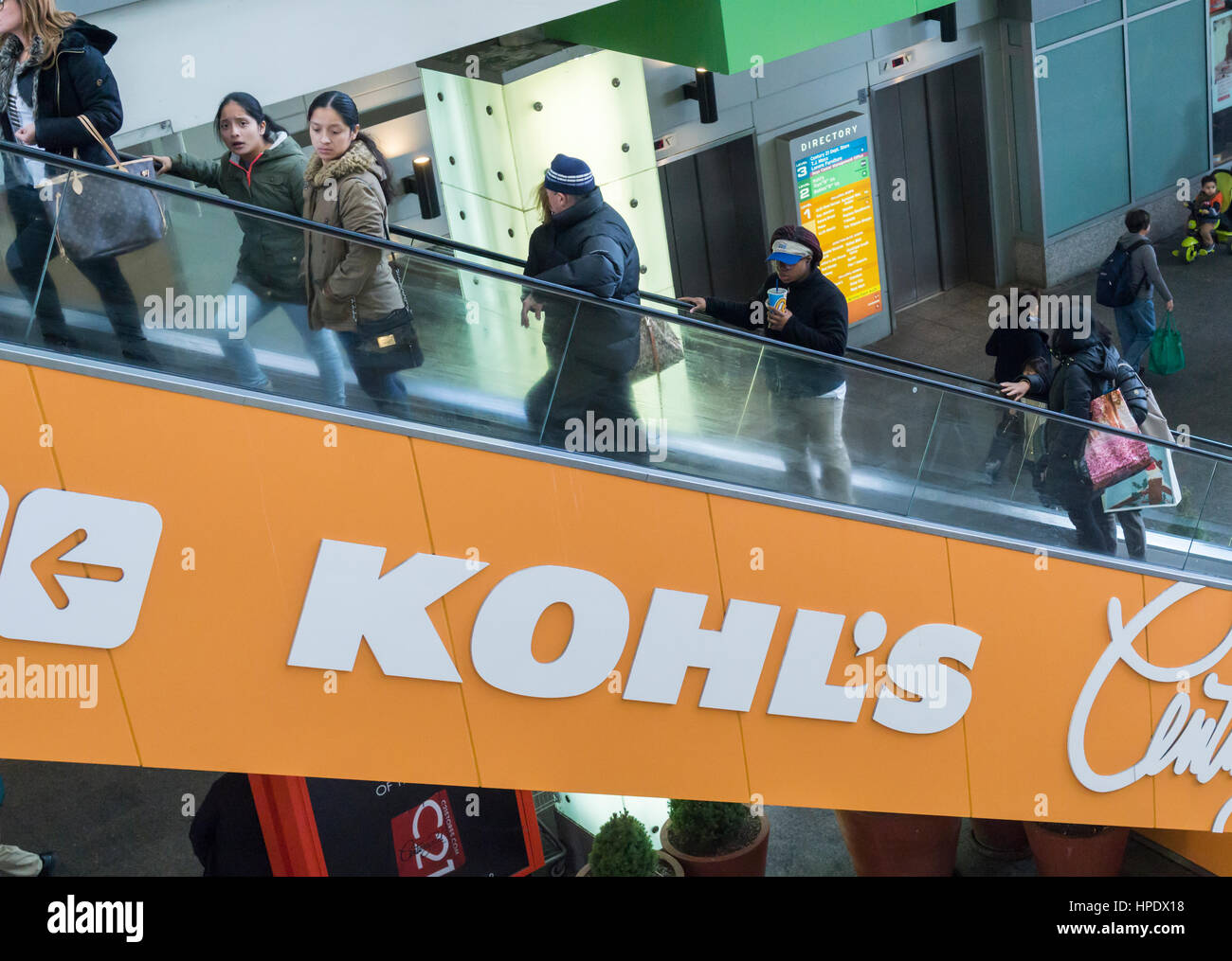 Shoppers ride an escalator up to Kohl's and other stores in the Rego ...