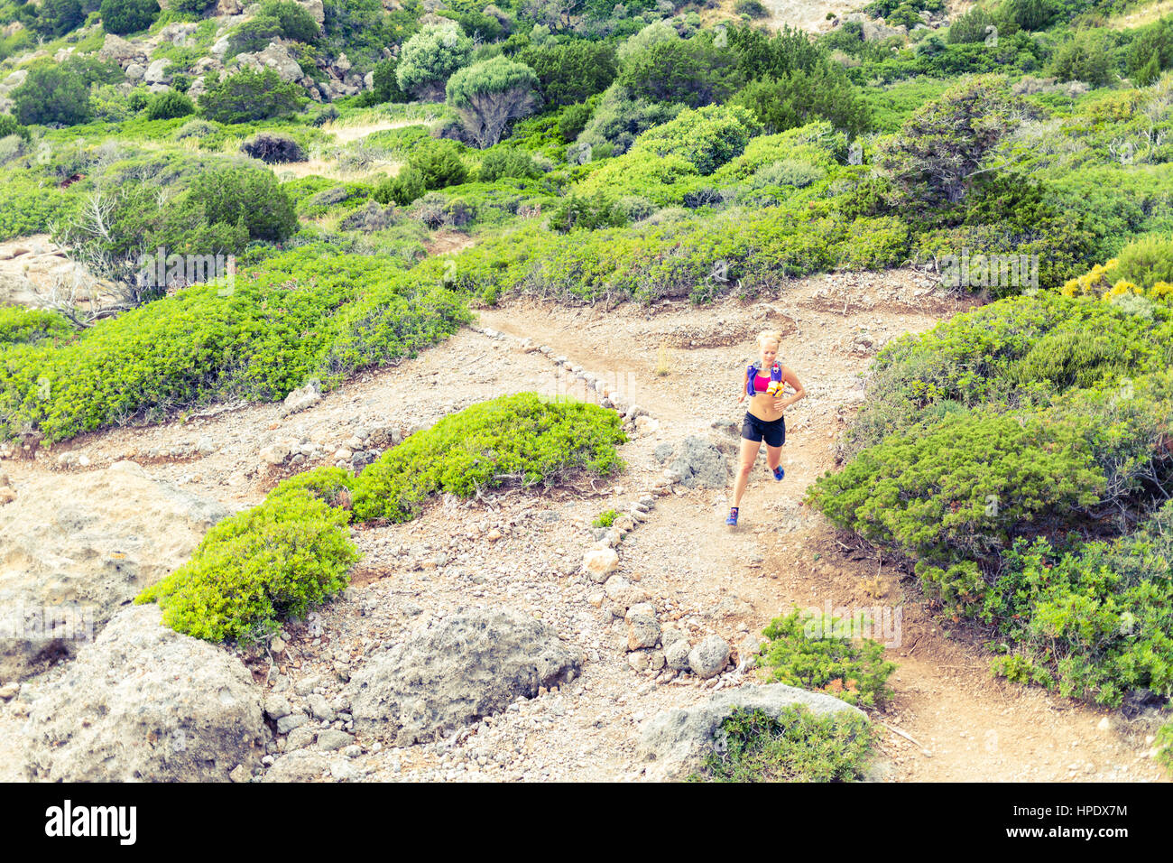 Trail running woman cross country running in mountains on summer ...